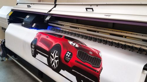 Vinyl banner printing process with an image of a car | Front Signs