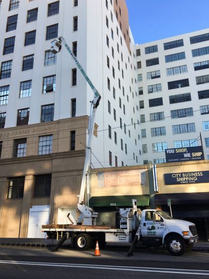 Sign installation process on a tall building | Front Signs