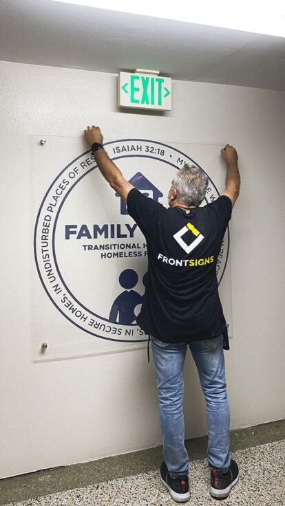 Family Floor vinyl lettering and acrylic sign installation | Front Signs