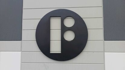 Fine Fixtures building sign installation | Front Signs