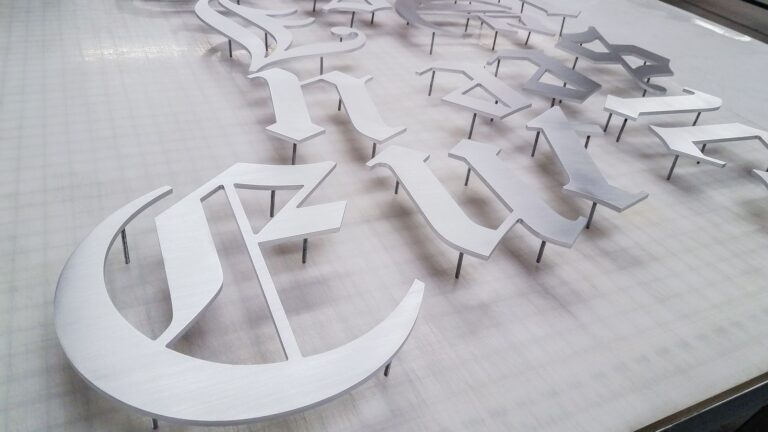 Pin mounted 3 dimensional brushed aluminum signage | Front Signs