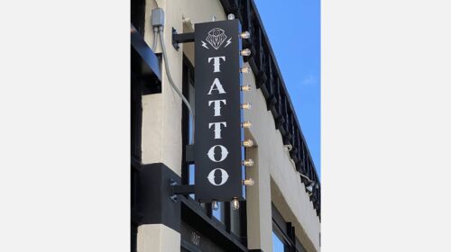 Double-sided wall-blade lightbox sign for a tattoo store | Front Signs