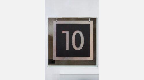 Acrylic and Aluminum number sign in our showroom | Front Signs