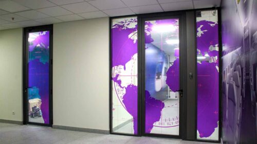 World map displayed on glass doors with clear vinyl | Front Signs