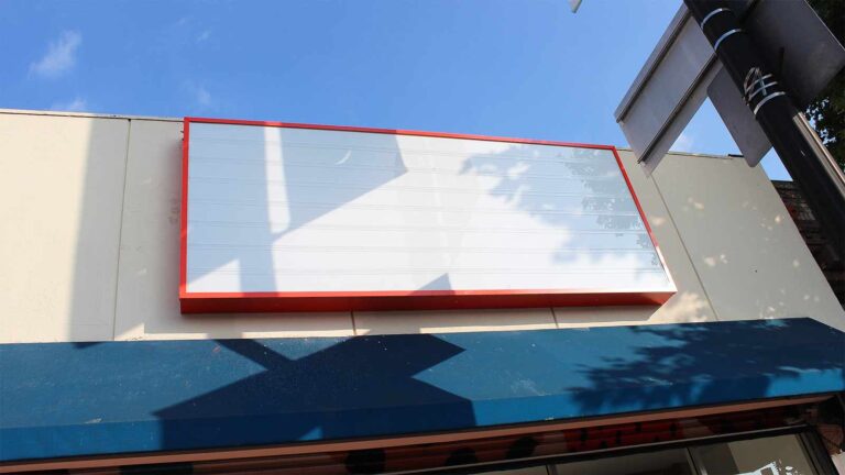 Cinema marquee lightbox sign fixed on the building | Front Signs