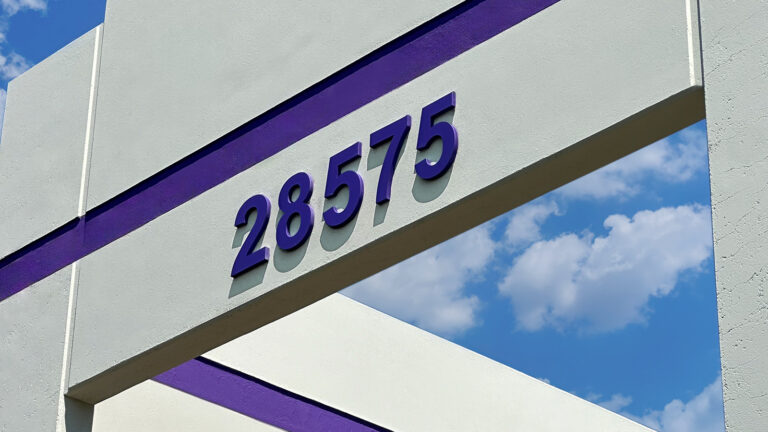 Nusano violet PVC sign featuring address numbers | Front Signs