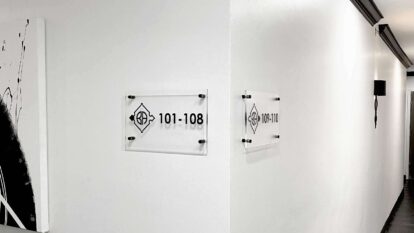 Wall-mounted acrylic signs with black numbers | Front Signs